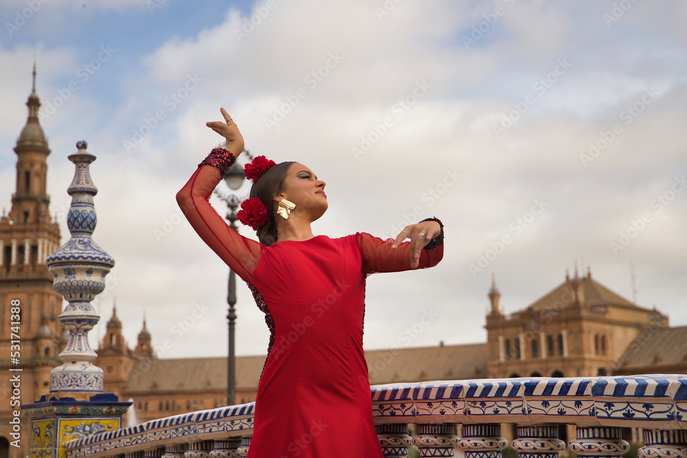 Young teenage woman in red dance suit with red carnations in her hair ...
