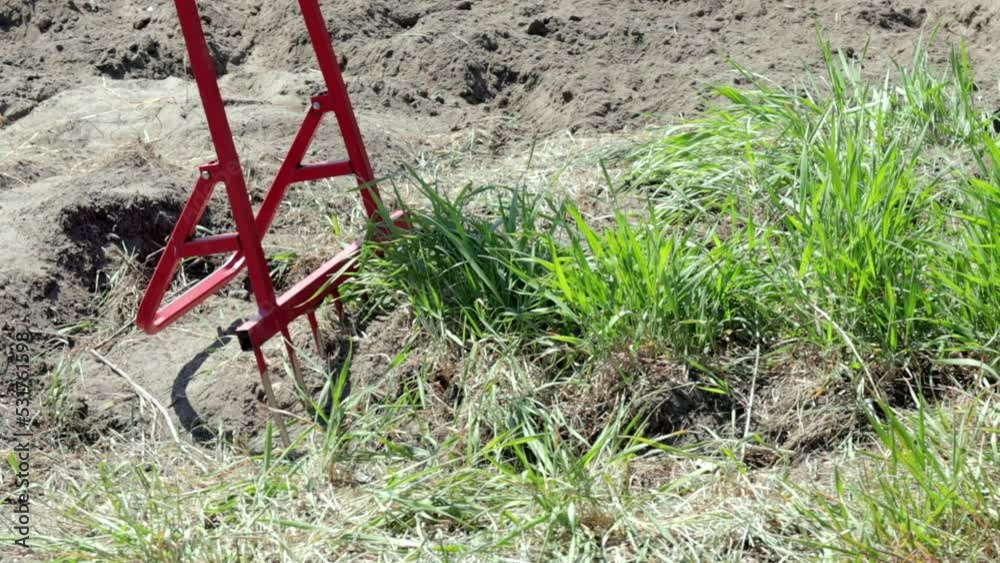Red shovel in the form of a fork in the garden. Miracle shovel, handy ...