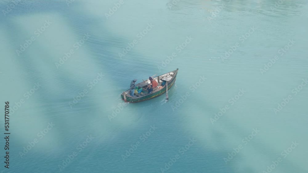 Fishing boat carrying lots of fishes in its back is returning back to ...