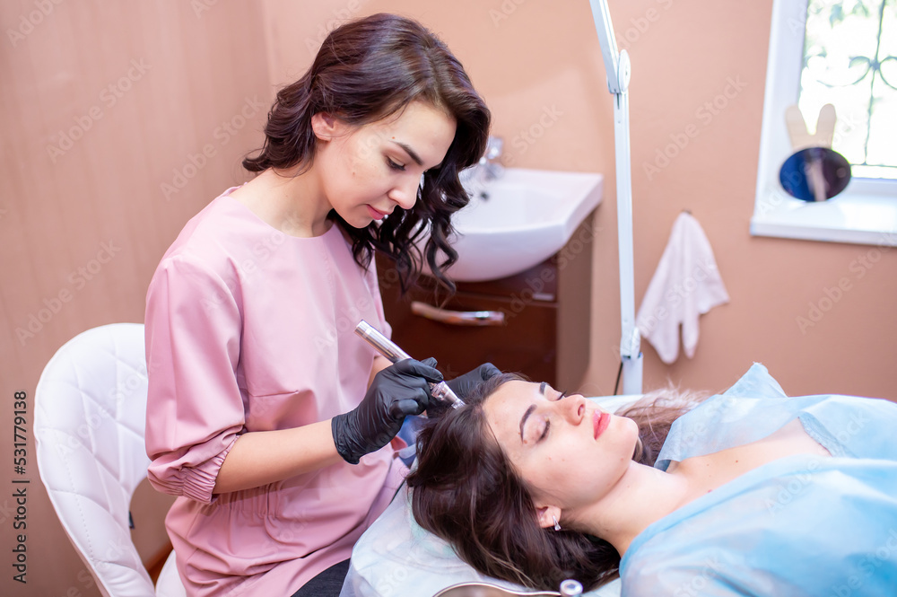 Treatment of the scalp for hair loss, alopecia. A trichologist doctor ...