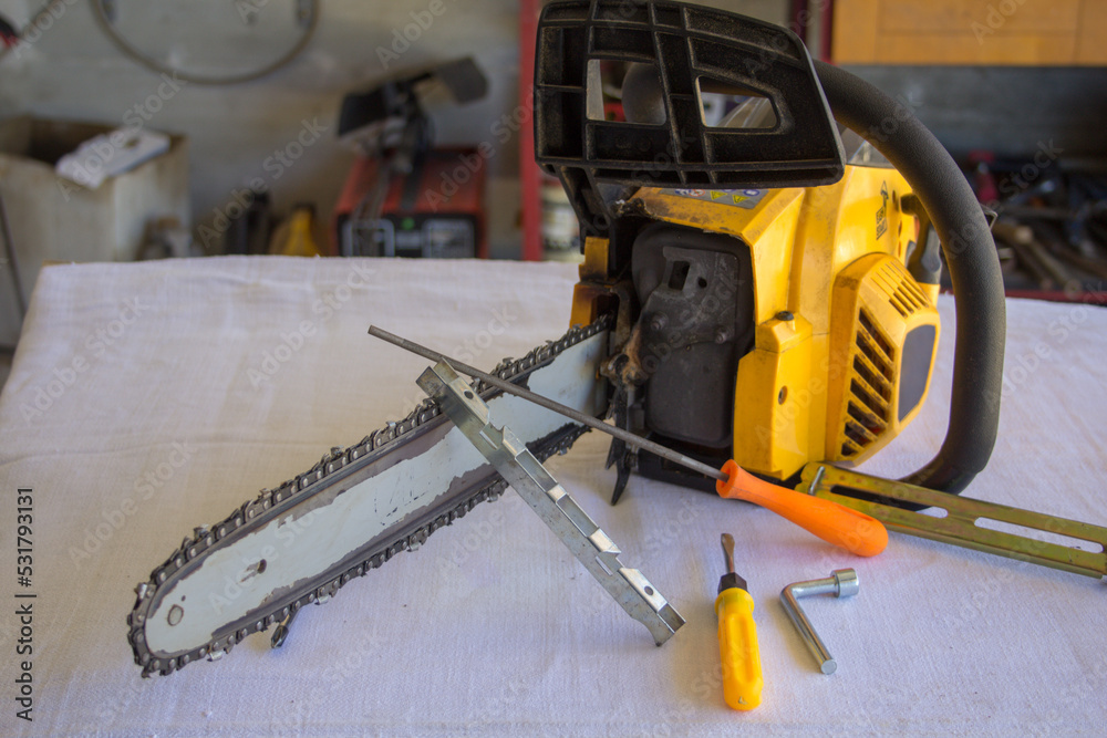Image of a chainsaw with tools to sharpen the chain. Preparation of ...