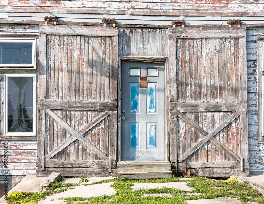 The front doors of a repurposed old livery stable with modern windows ...