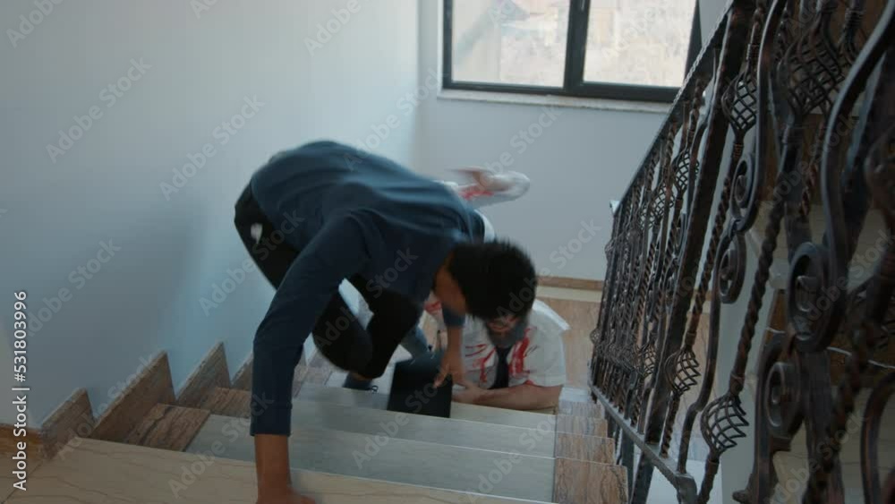 Frightened worker on emergency stairway running away from scary looking ...