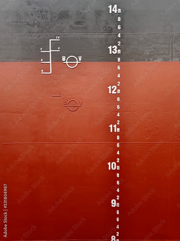 A mid draft mark, load line and plimsoll mark on a side of cargo ship ...