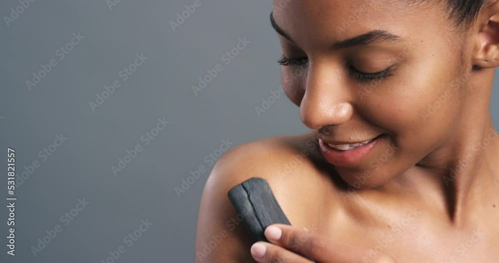 Body scrub, charcoal and skincare woman in studio for wellness ...