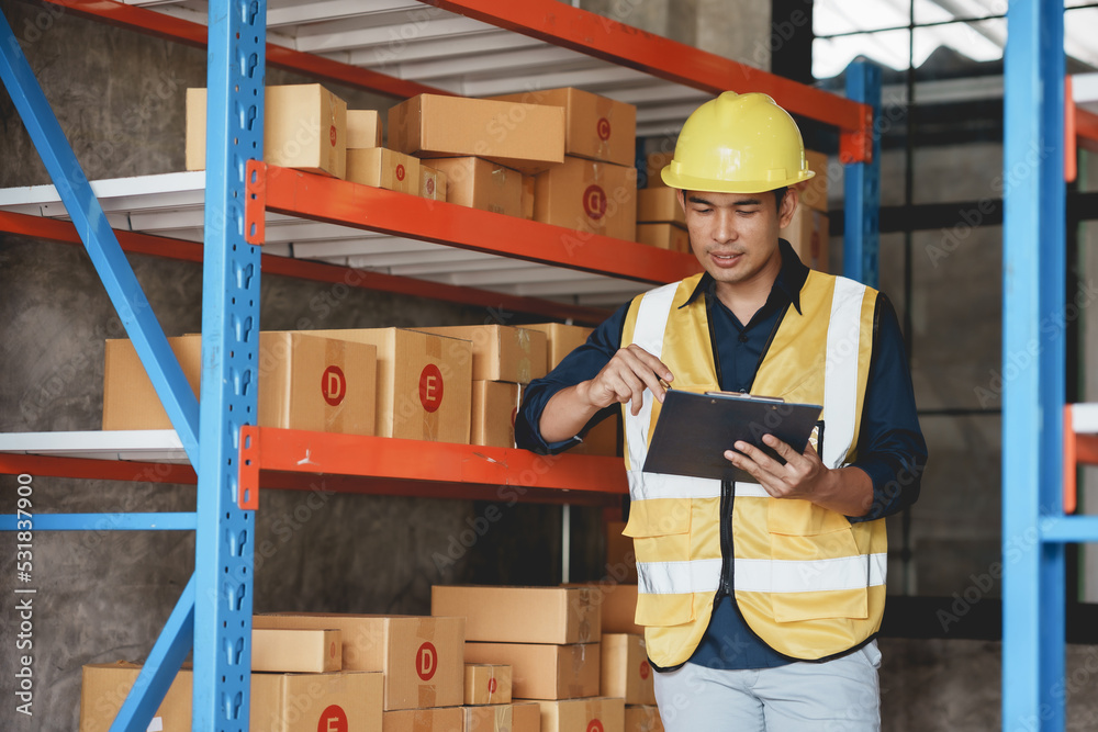 Asian male warehouse worker check and count inventory in the warehouse ...