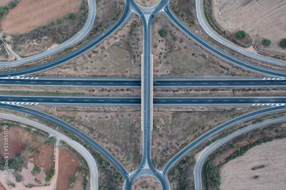 Aerial view of a bridge and highway lanes, roundabouts and conjunctions ...