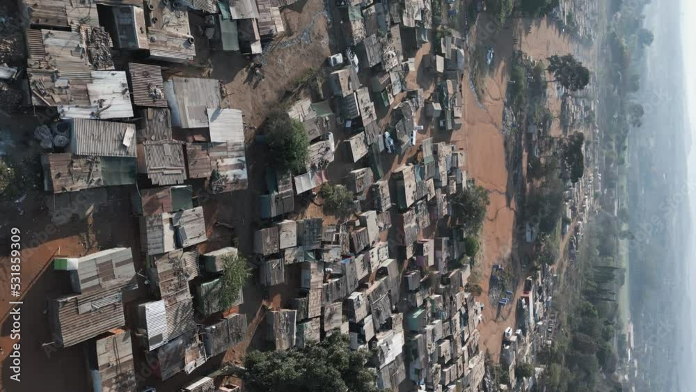 Vertical video.Poverty.Inequality.Aerial view of densely over crowded ...