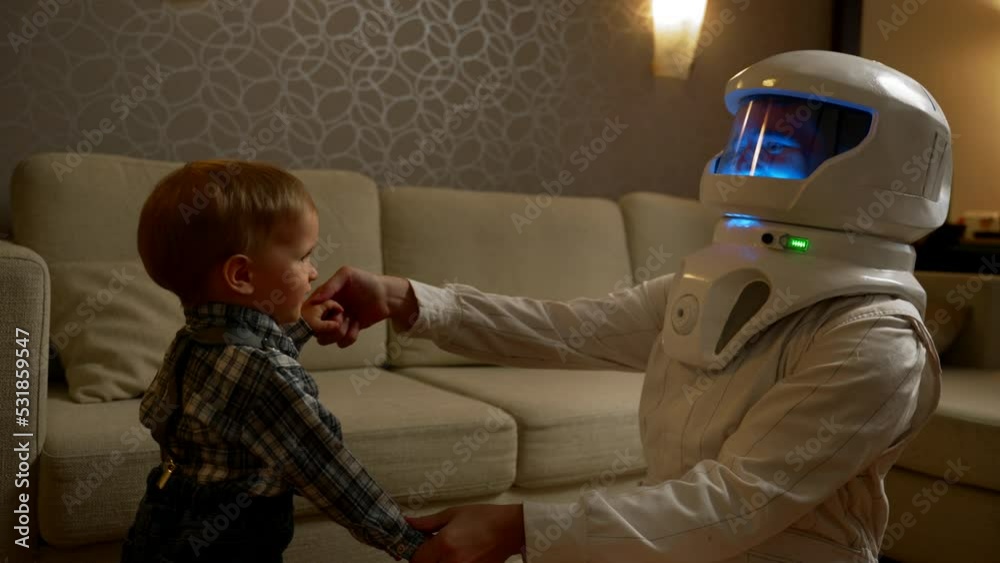 Video Stock A father in an astronaut costume dances with his son ...