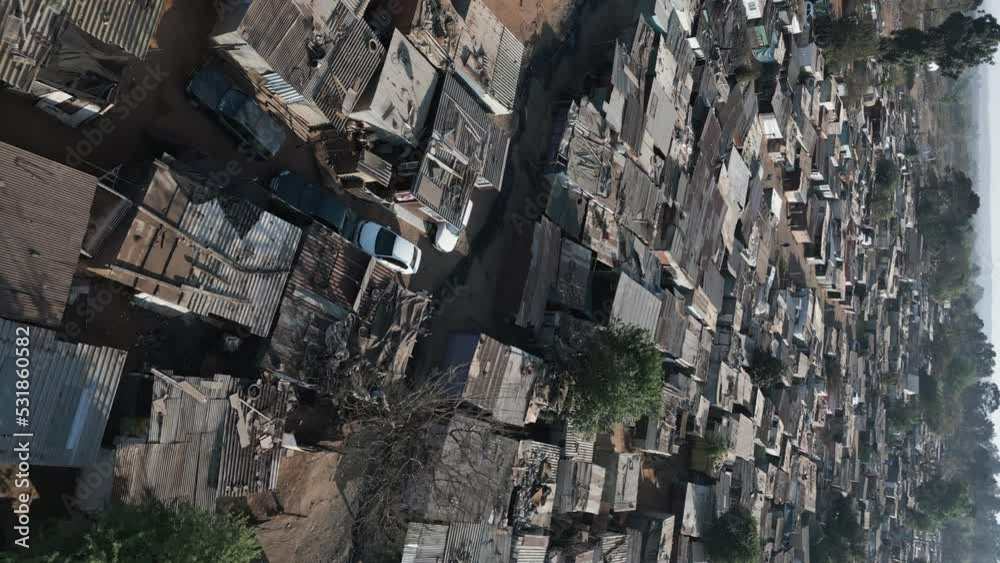Vertical video.Poverty.Inequality.Aerial view of densely over crowded ...