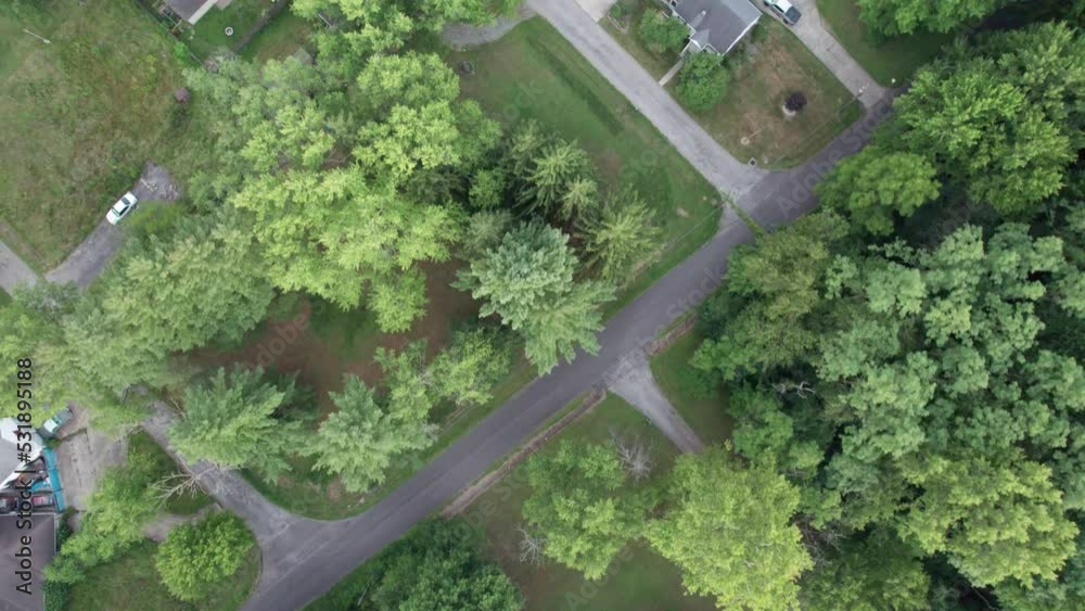 Drone footage of a quiet suburb with clear roads and many houses that ...
