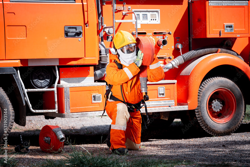 Firefighter man wearing protective fire suite and helmet with equipment ...