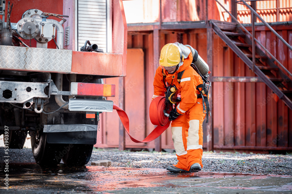 Firefighter man wearing protective fire suite and helmet with equipment ...