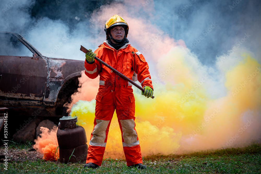Firefighter man wearing protective fire suite and helmet with equipment ...