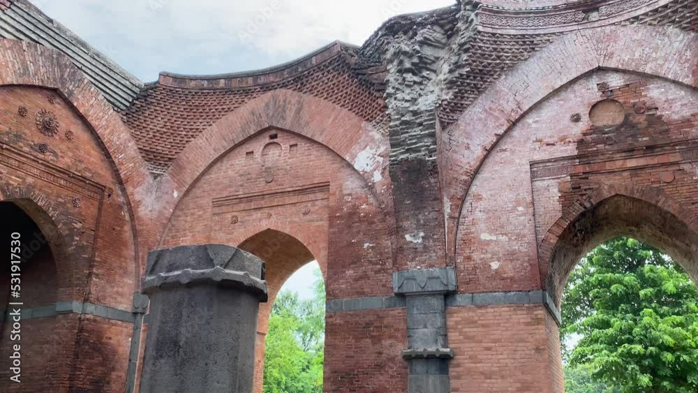 The crumbling remains of a broken hall with stone arches at the ...
