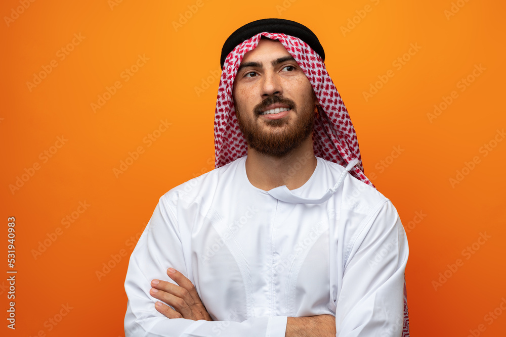Portrait of young smiling Arab man on orange background Stock Photo ...