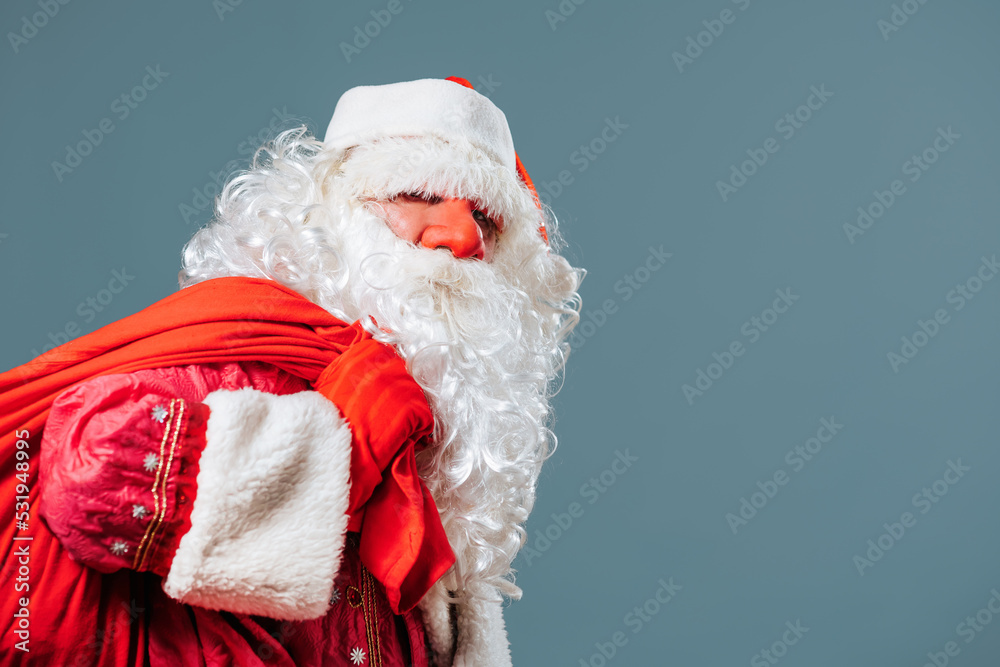 Santa Claus red nose on the blue background front view is leaning under ...