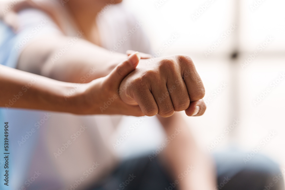 Physical therapist is examining the injured arm, waist and neck muscles ...