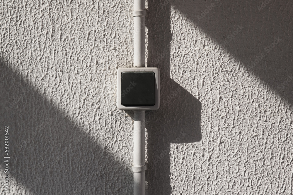 Simple electric switch on the white grungy wall, power toggle, flat ...