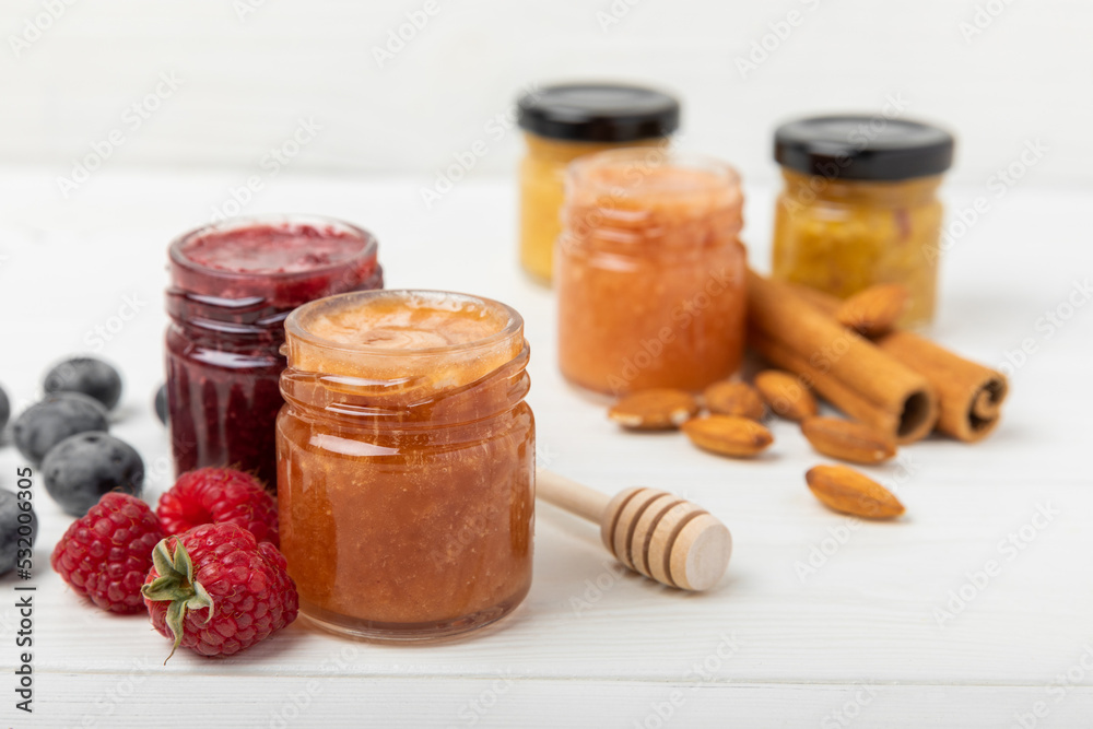 Jar of honey. Fruit honey with raspberries, blueberries, almonds and ...