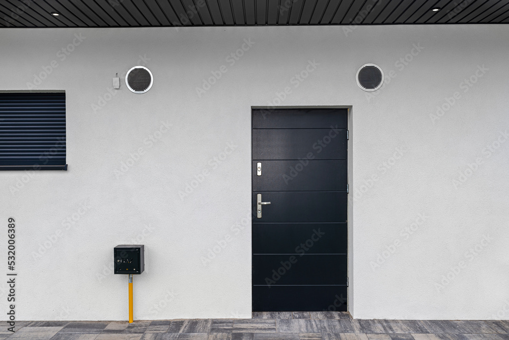 Air intake and exhaust in the wall of a single family house for ...