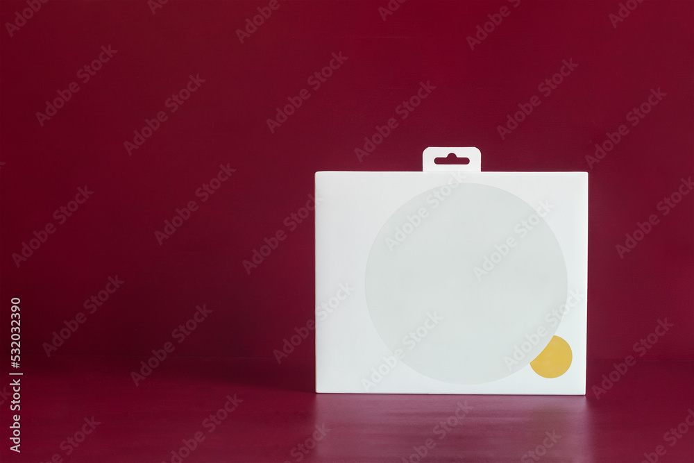 A white cardboard box with a large blank grey circle and a small gold ...