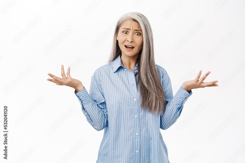 Confused japanese middle aged woman looking questioned and frustrated ...