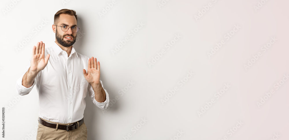 Displeased man rejecting something disturbing, showing stop sign and ...