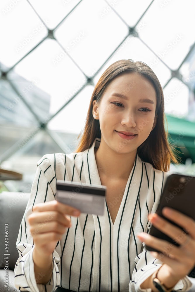 Close up photo of young asian beautiful female lady making a payment ...