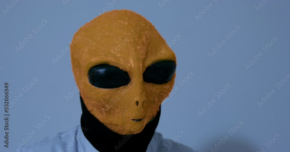 Alien looks around and does strange movements shaking head in room ...