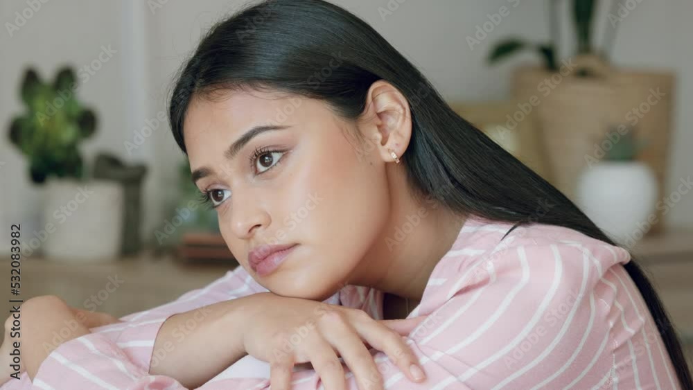 Depressed, sad woman at home looking out window for mental health ...