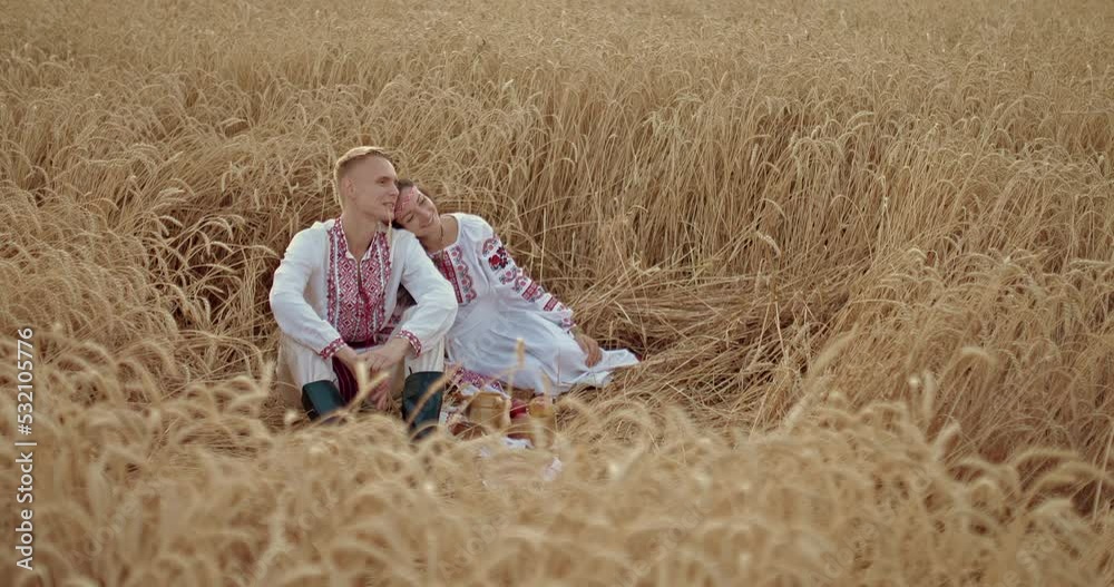 Beautiful people Slavs are sitting in a field and admiring nature. Rest ...
