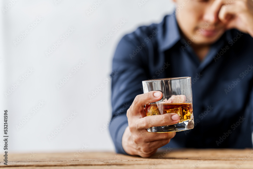 Sad depressed addicted drunk guy, Alone asian man drinker alcoholic sitting at bar counter with ...