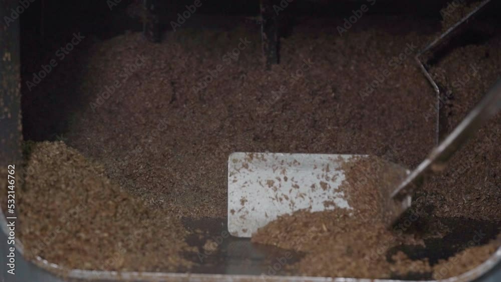 Cleaning out the spent grain waste from the manufacturing equipment ...