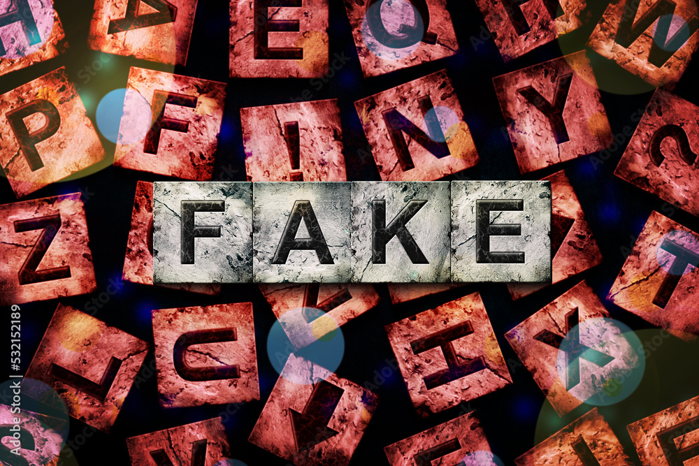 Fake, word on an alphabet on stone blocks, on a red background, with ...