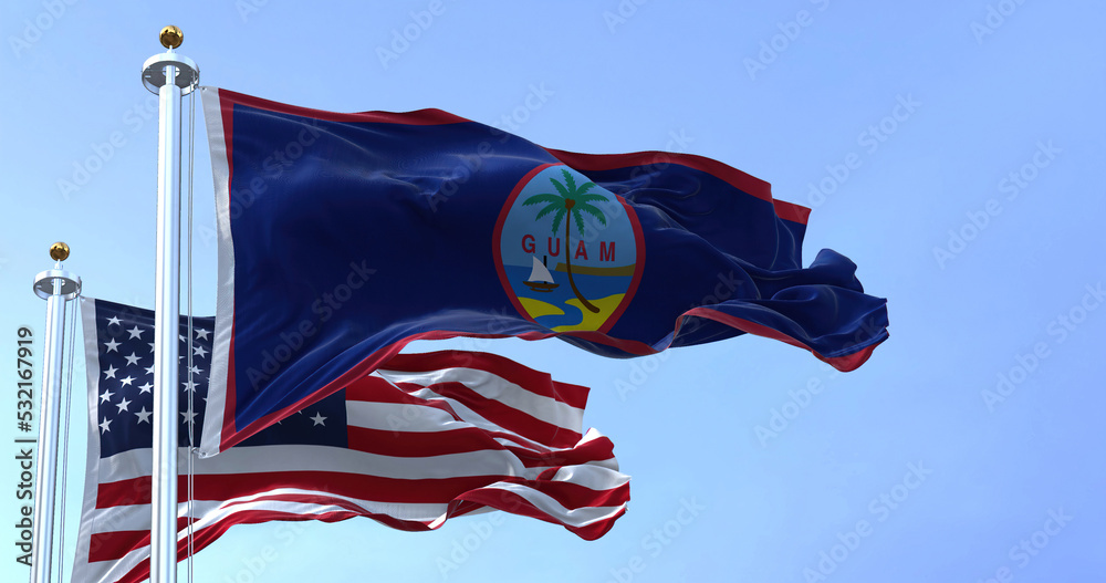 Flag of Guam waving in the wind with the US flag on a clear day Stock ...