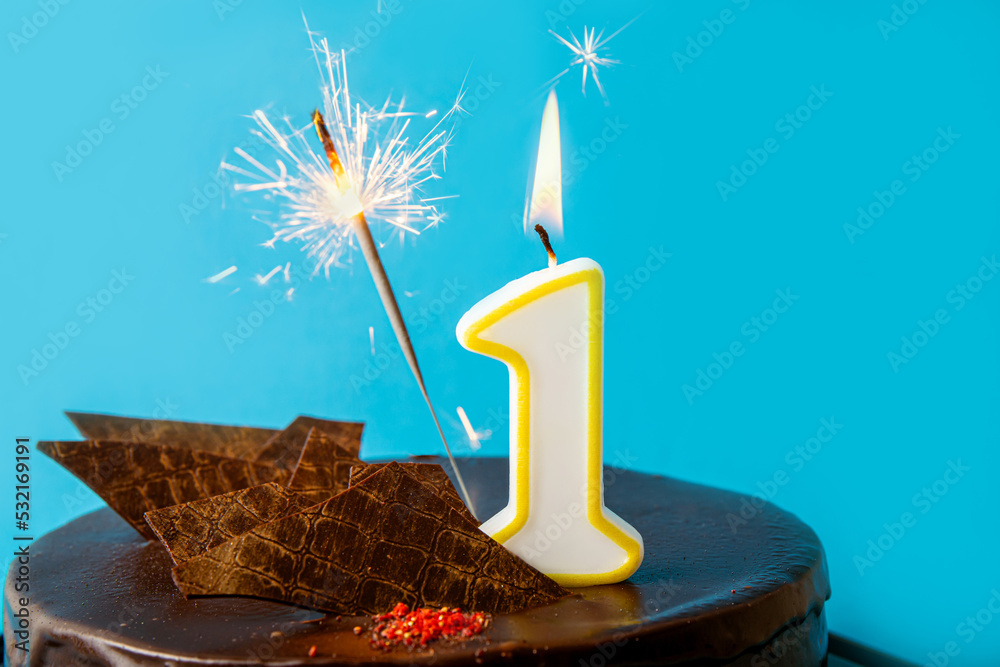 Number 1 birthday candle burning and sparkler with sparks fly on cake ...