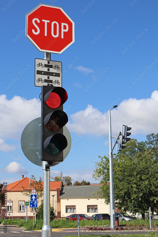 Red traffic light and stop sign at the road crossing Stock Photo ...