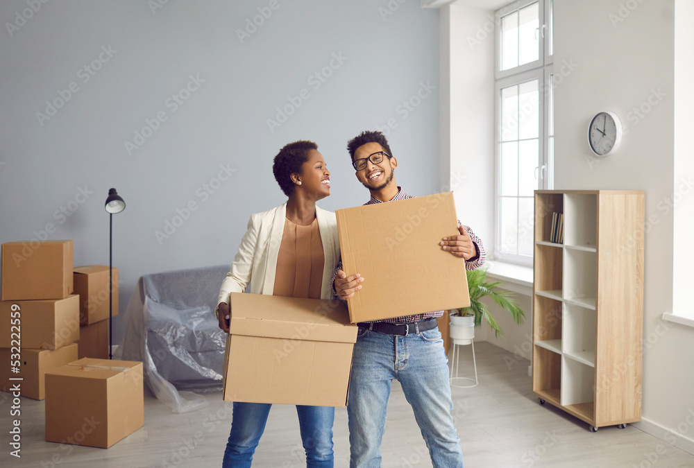 Portrait of overjoyed ethnic couple celebrate moving relocating to new ...