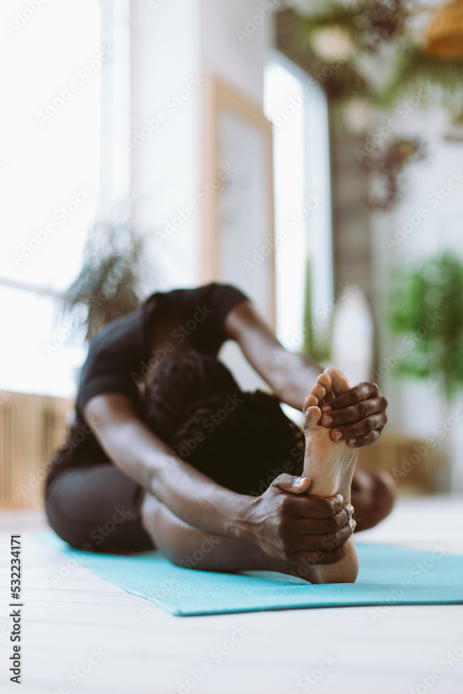 Vertical athlete african american woman with dreads in black sportswear ...