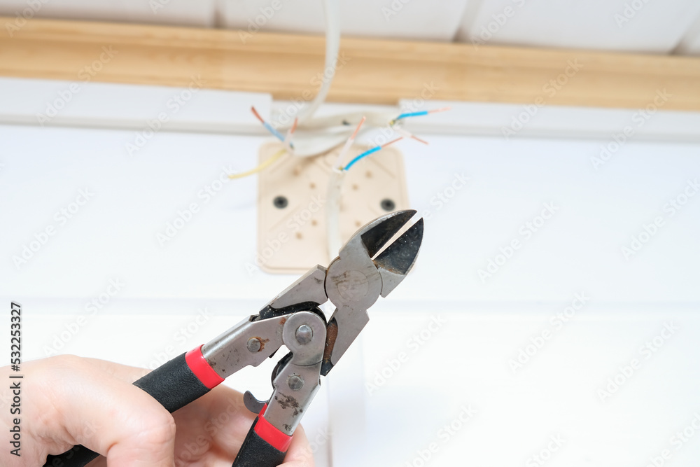 Electrician use of the stripper cutter tool to strip the end of the ...