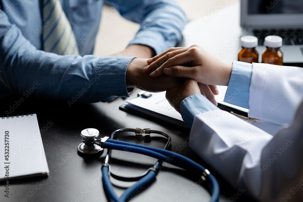 Doctor shook hands to encourage the patient after informing the results ...