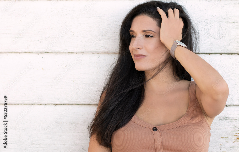 Attractive, confident Middle Eastern looking woman in her 30s leaning ...