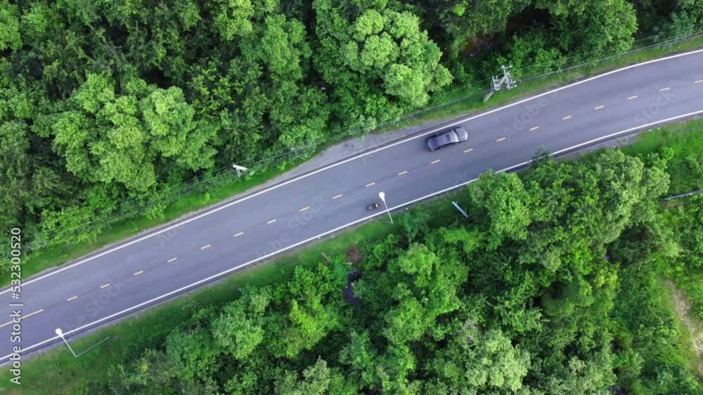 Two lane road The two sides of the road are full of trees and there are ...