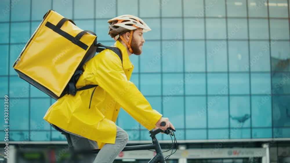 Video Stock Handsome Delivery Person in Yellow Uniform Riding a Bike ...