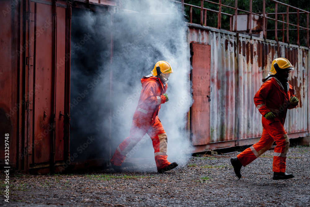 Firefighter with fire suite standing in front of frightening explosion ...