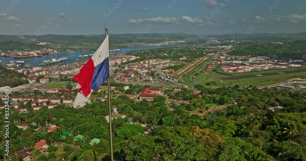Panama City Aerial v65 panoramic view fly around national flag on ancon ...