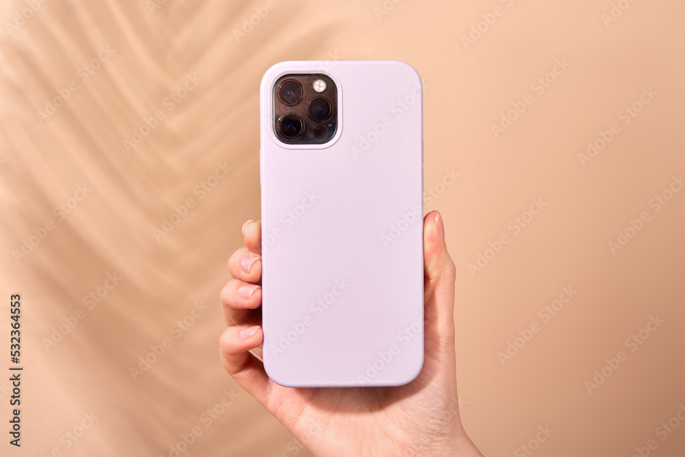 Female hand holding white smartphone in soft silicone cover back view ...