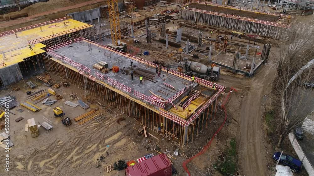 Construction cranes with new buildings under construction. Construction ...