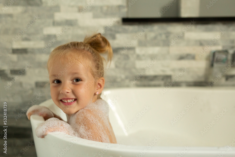 The girl bathes in a bath with white foam Stock Photo | Adobe Stock